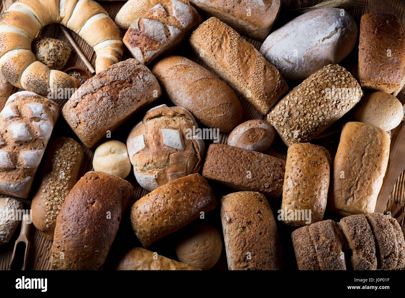 Mixed bread top view shot. Different fresh bread on old wooden table ...