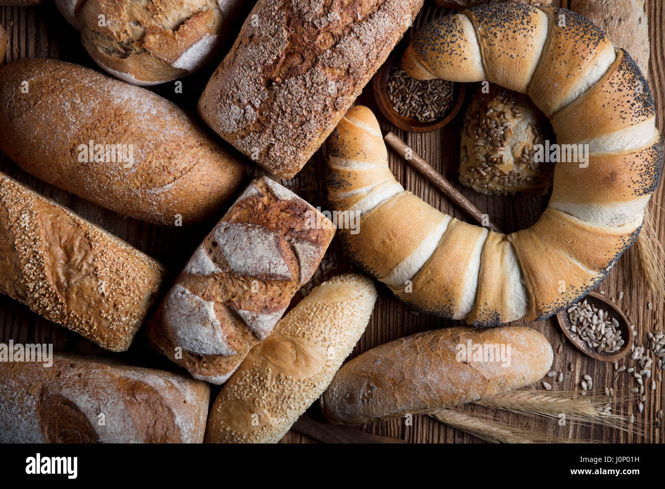 Mixed bread top view shot. Different fresh bread on old wooden table ...