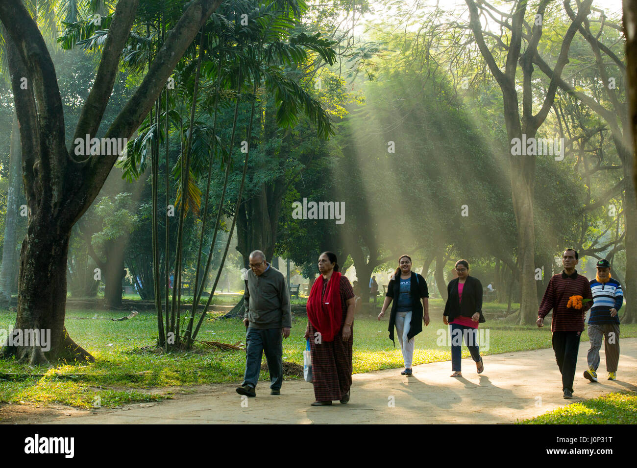 Dhaka residents take a morning walk in the wintry weather in the Ramna ...