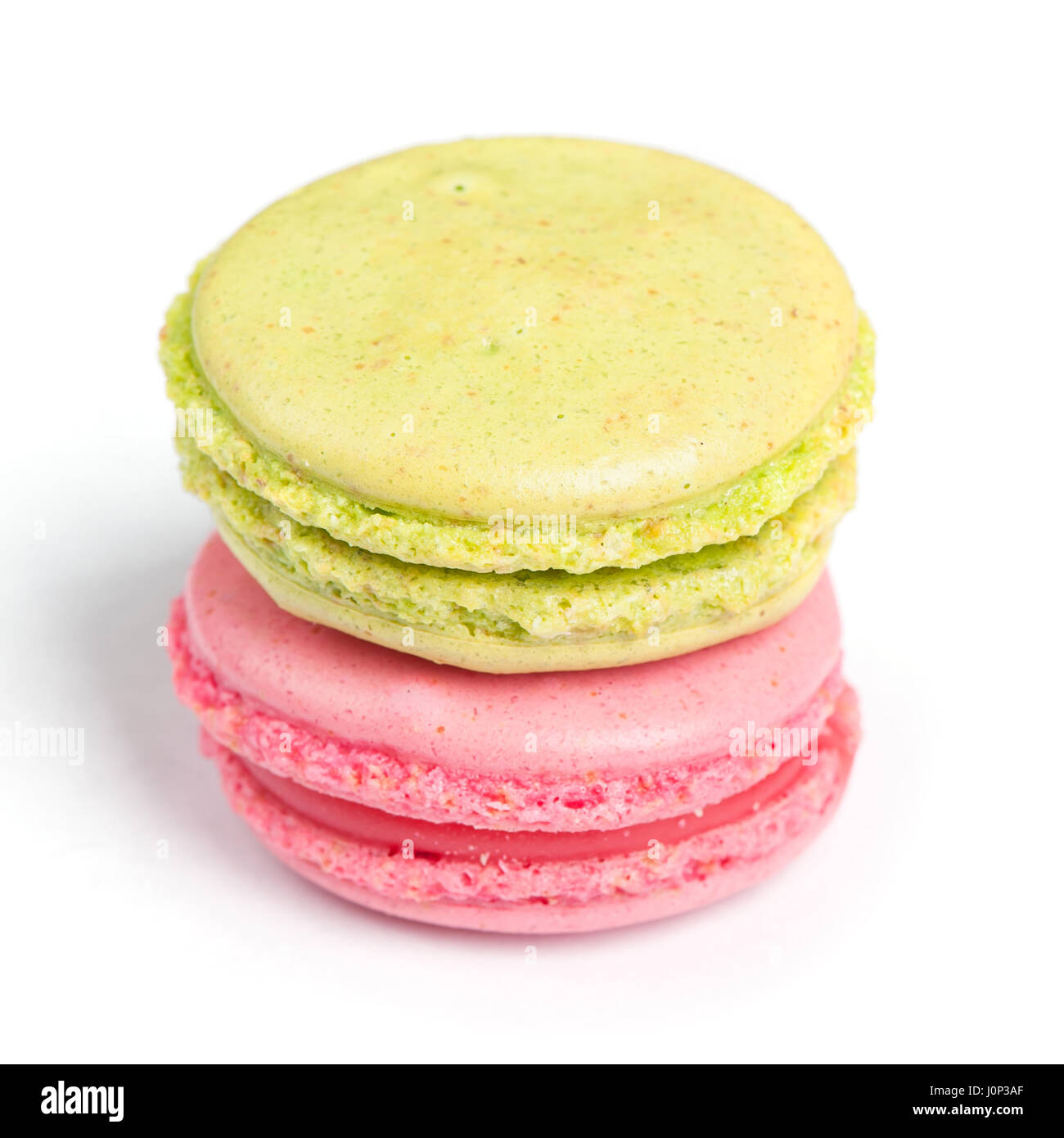 Tasty macaroons in two colors isolated on white background Stock Photo ...