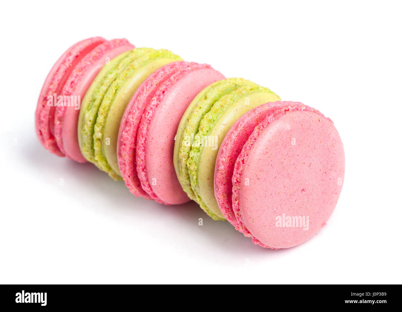 Tasty macaroons in two colors isolated on white background Stock Photo ...