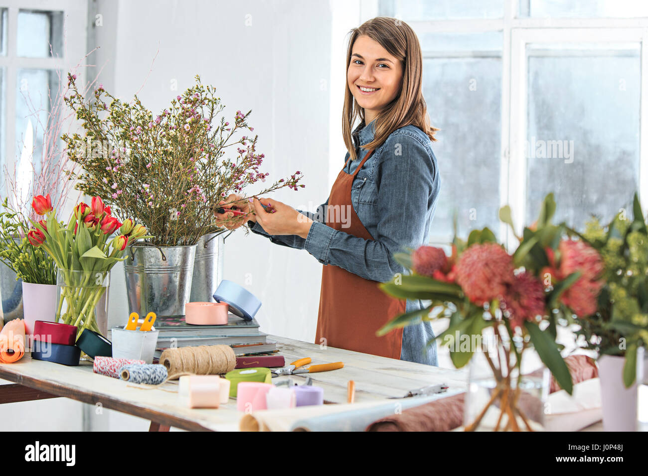 Florist at work: the young girl making fashion modern bouquet of ...
