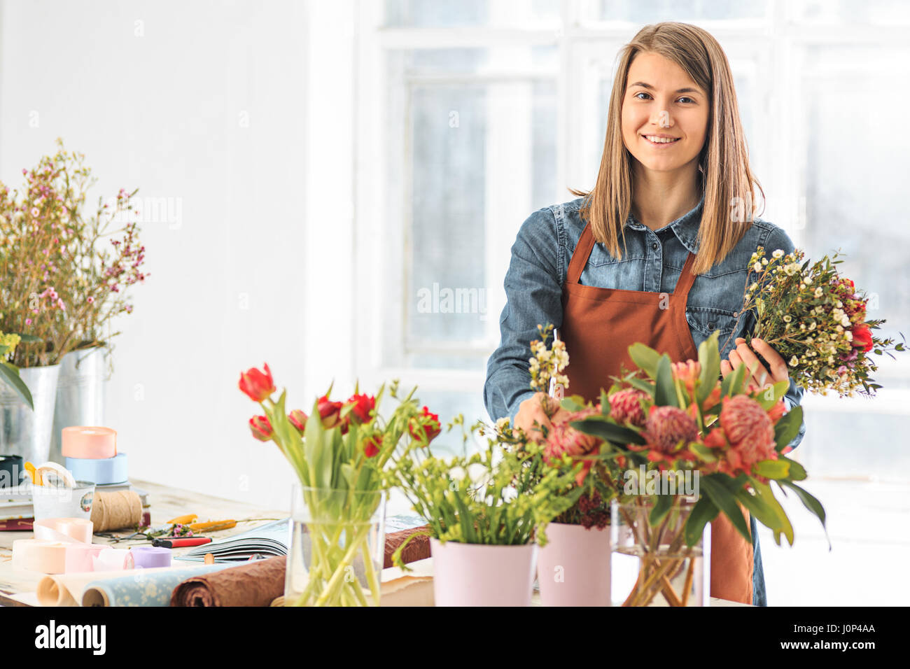 Florist at work: the young girl making fashion modern bouquet of ...