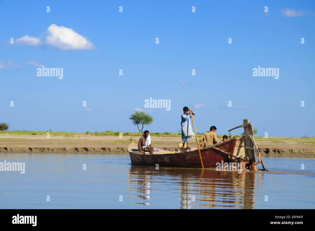 A boat on the bank of river to transport the villagers Stock Photo - Alamy