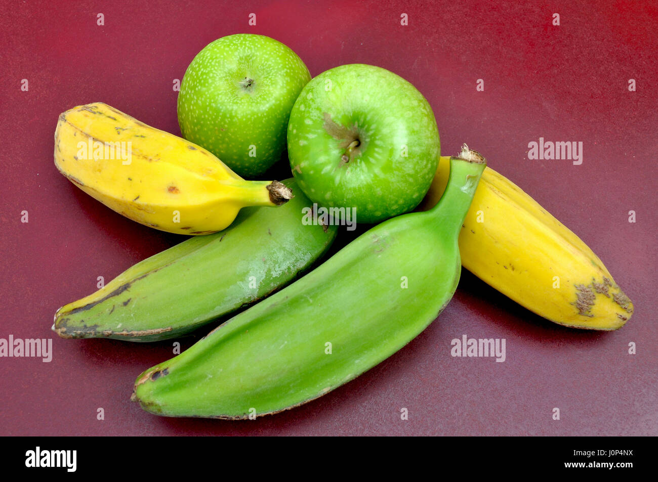 Green apples with green and yellow bananas Stock Photo - Alamy