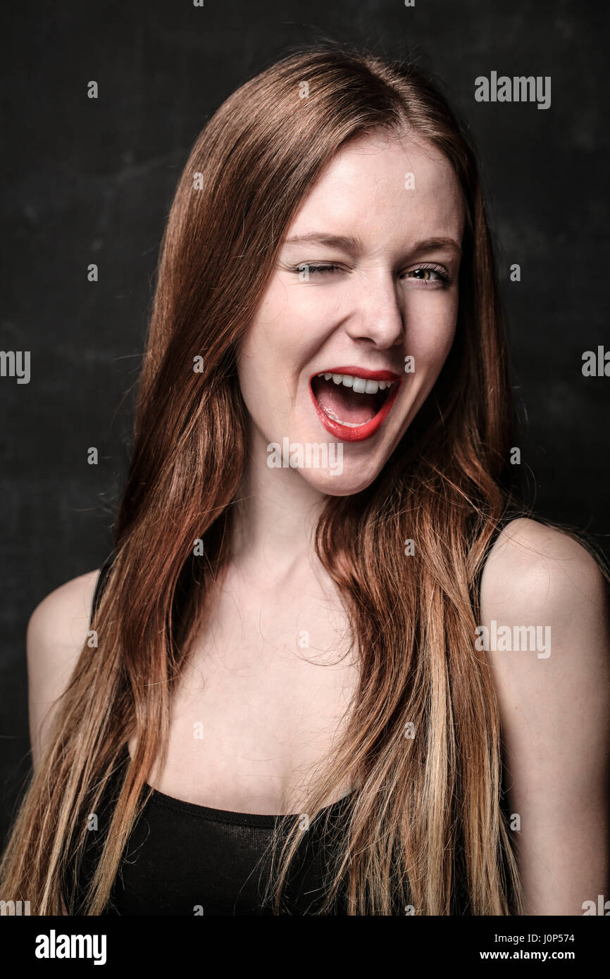 Young woman winking Stock Photo - Alamy