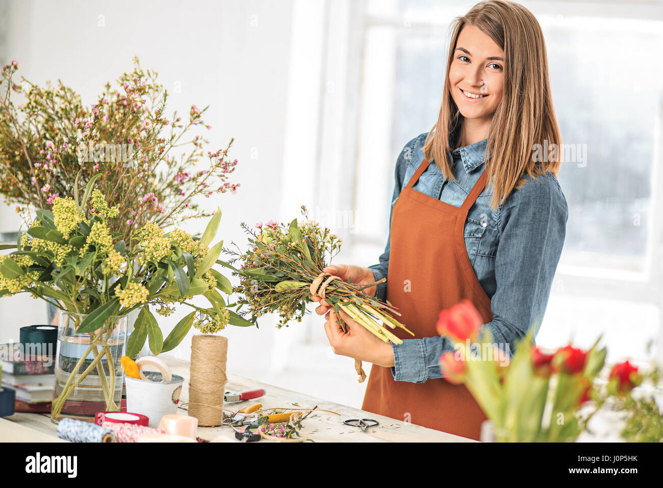 Florist at work: the young girl making fashion modern bouquet of ...