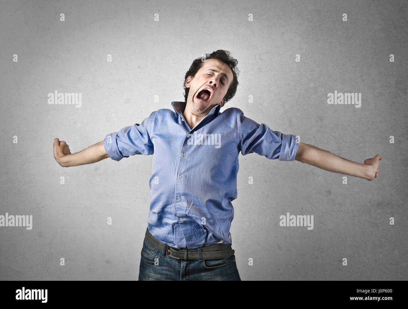 Tired man yawning inside Stock Photo - Alamy