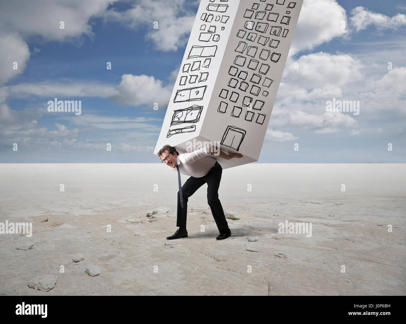 Businessman carrying paper building Stock Photo - Alamy