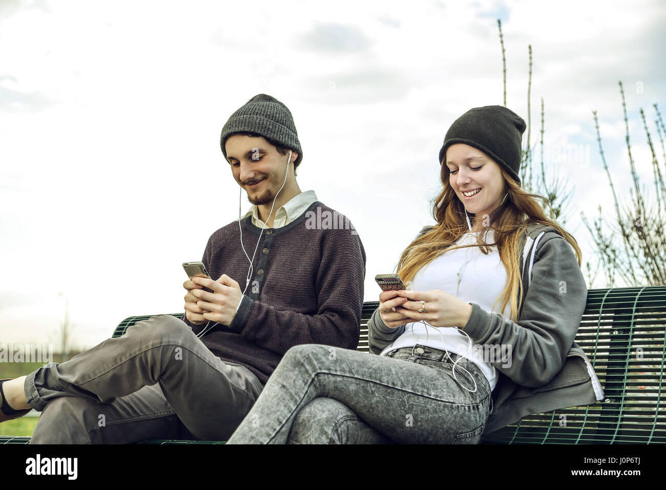 2 friends sitting on bench Stock Photo - Alamy