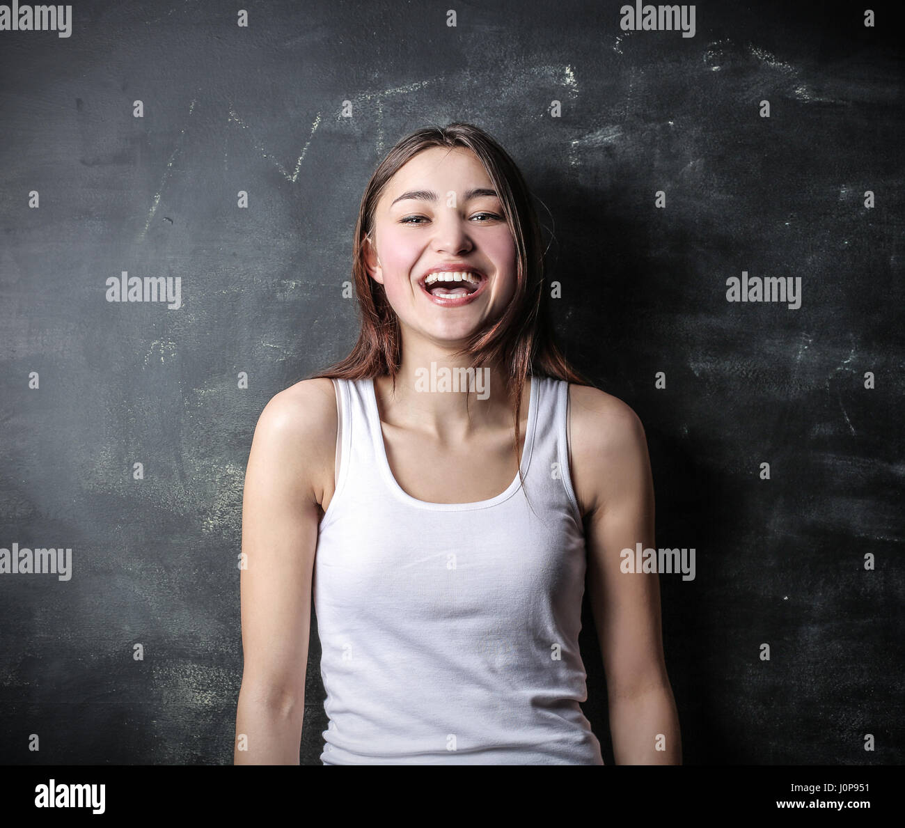 Young woman laughing inside Stock Photo - Alamy