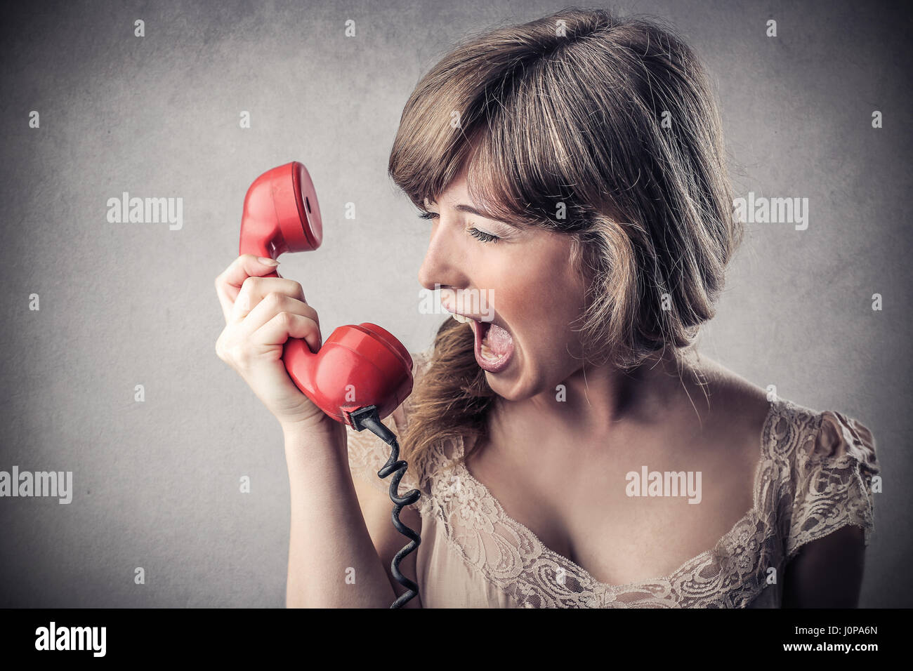 Woman yelling at phone hi-res stock photography and images - Alamy