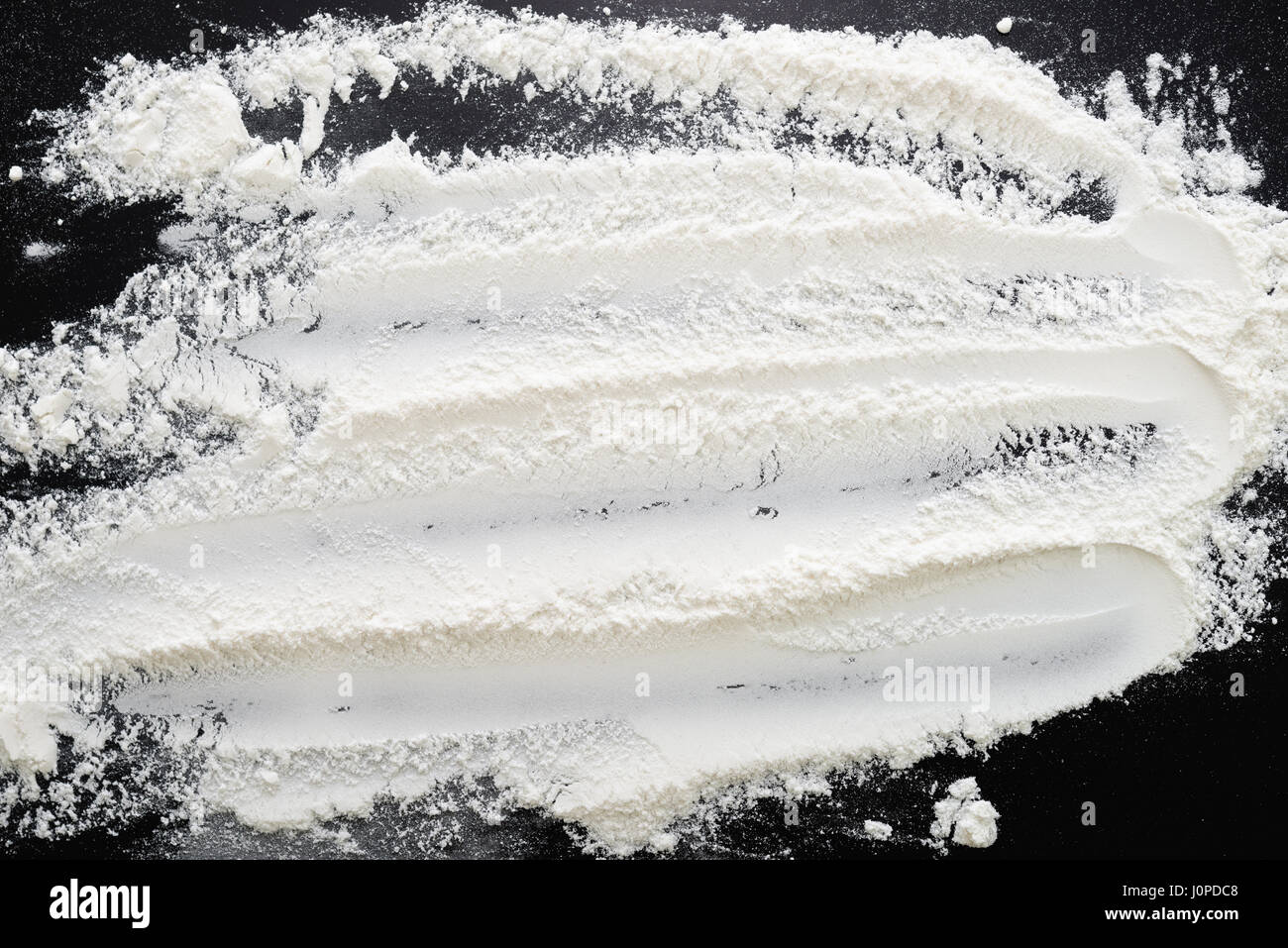 white powder (flour) on black background Stock Photo - Alamy
