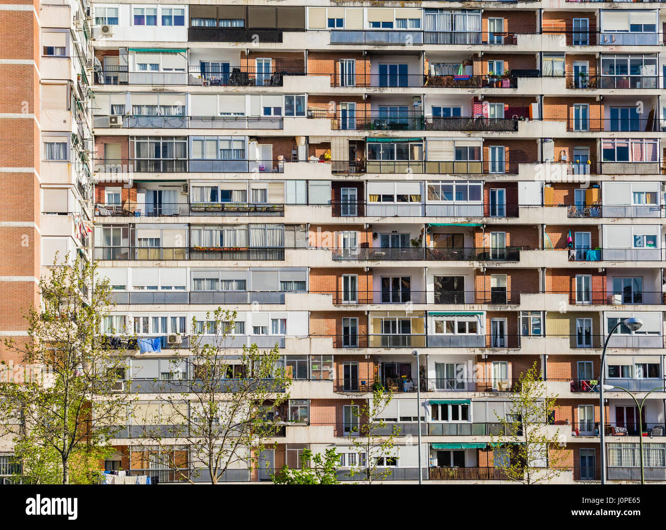 Anonymous apartment block with balconies full of various objects Stock ...