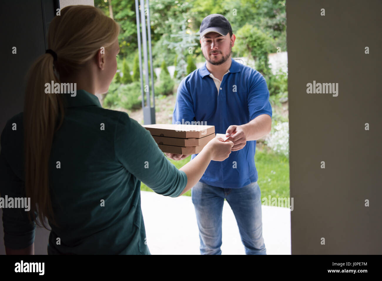 Pizza Delivery Man Giving Pizza Boxes To Smiling Young Woman Stock ...