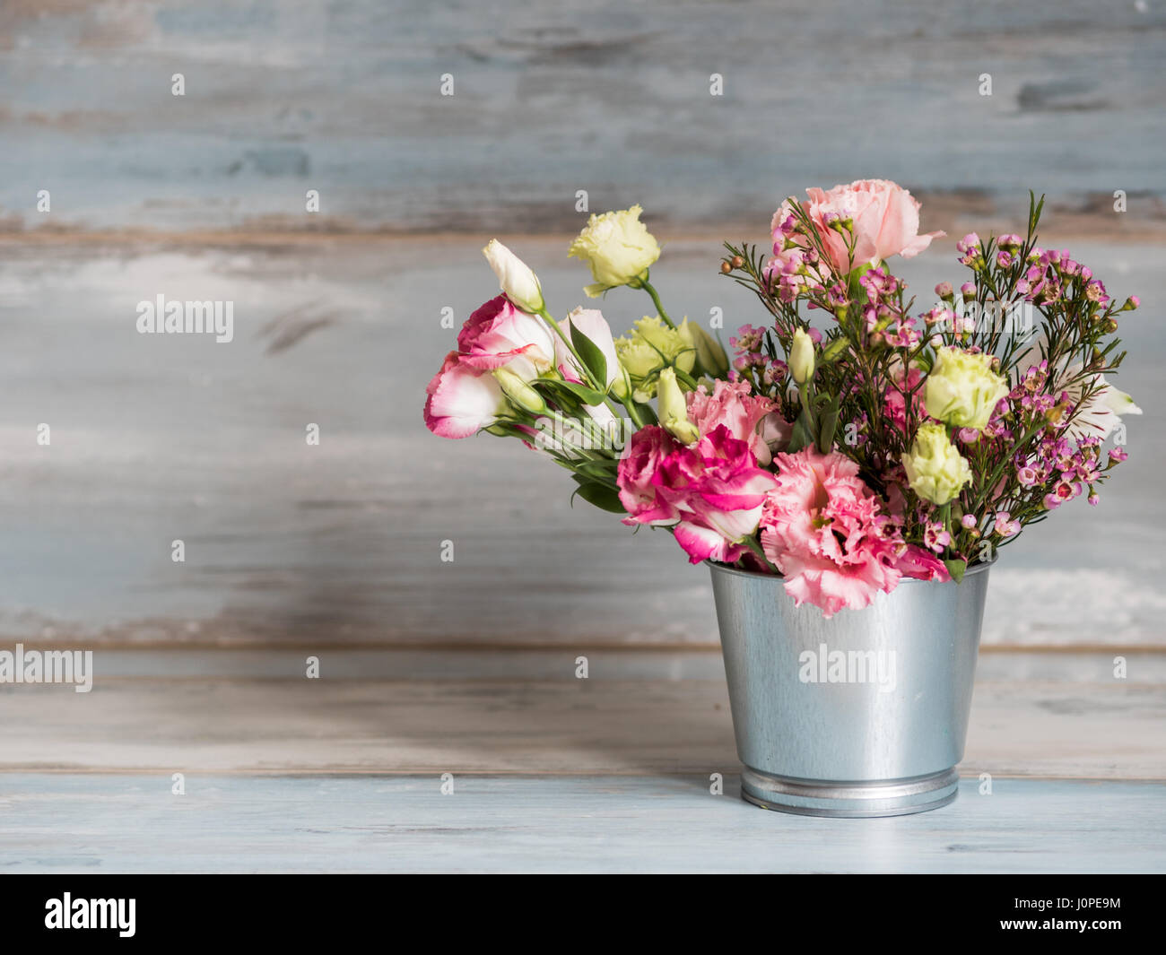 Spring flowers in small tin bucket Stock Photo - Alamy
