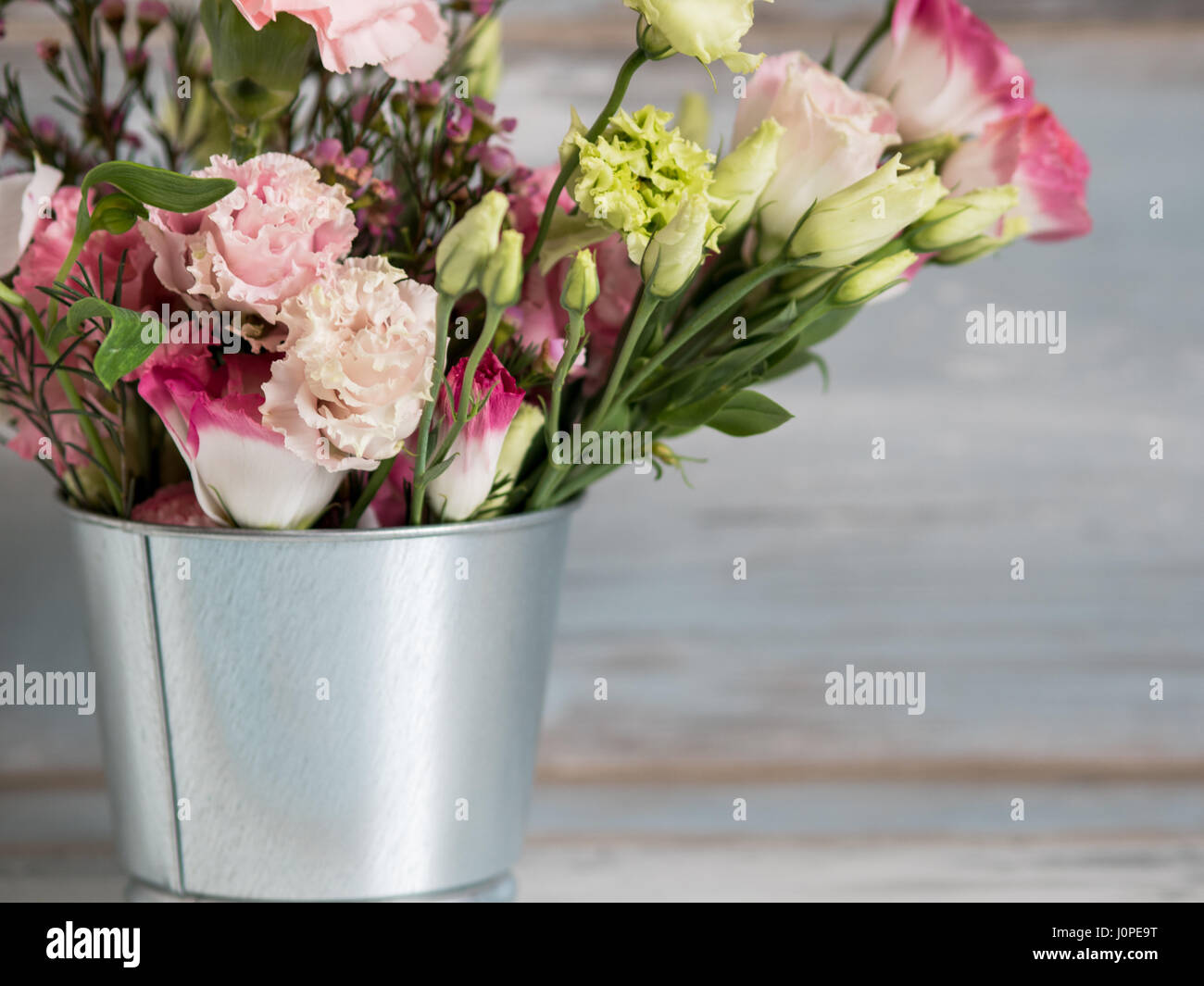 Spring flowers in small tin bucket Stock Photo - Alamy