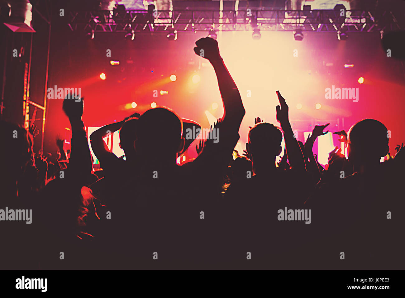 silhouettes of a massive crowd at the party concert club music happy ...