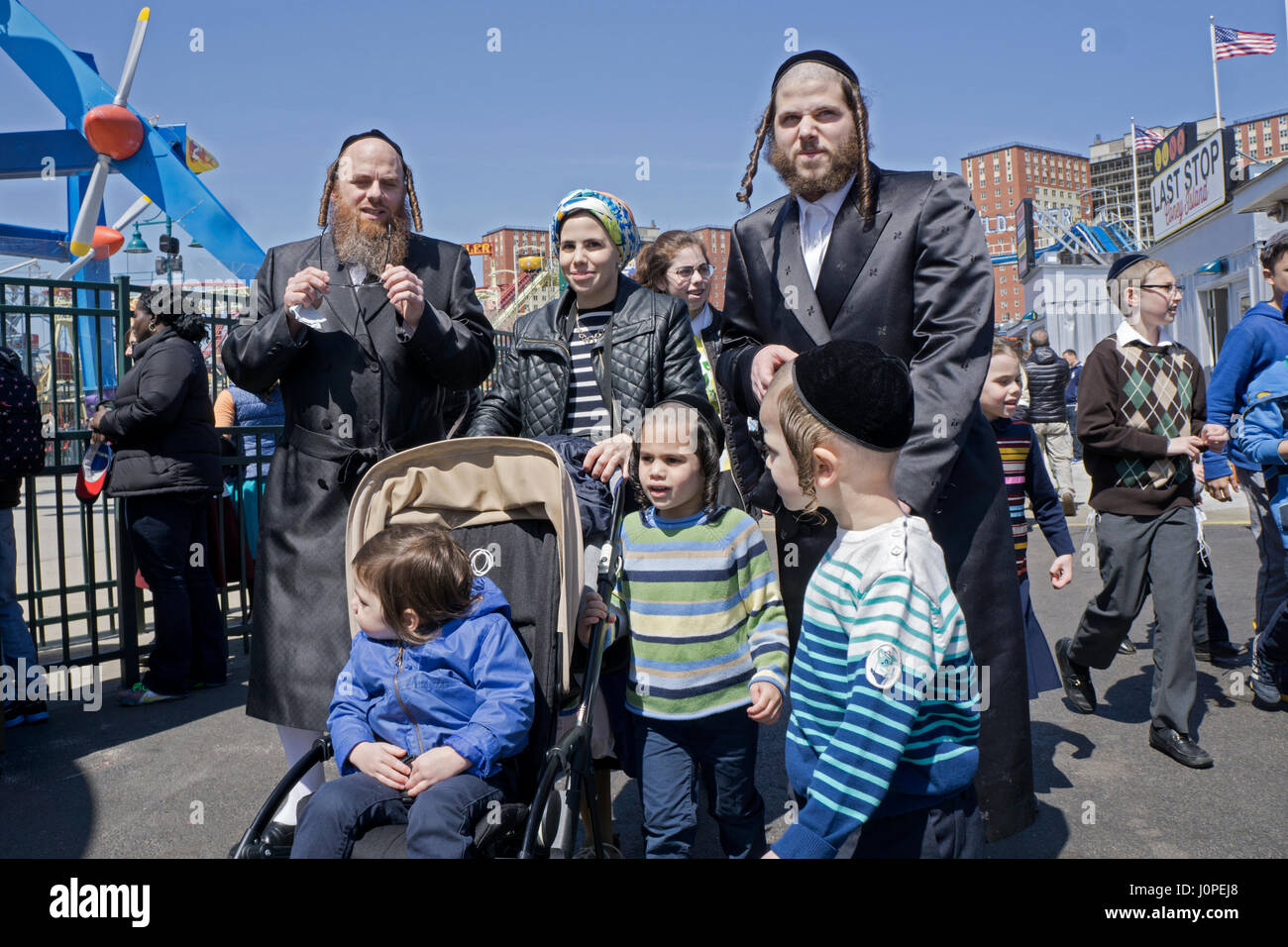 A religious Jewish family having fun during Passover at Luna Park in ...