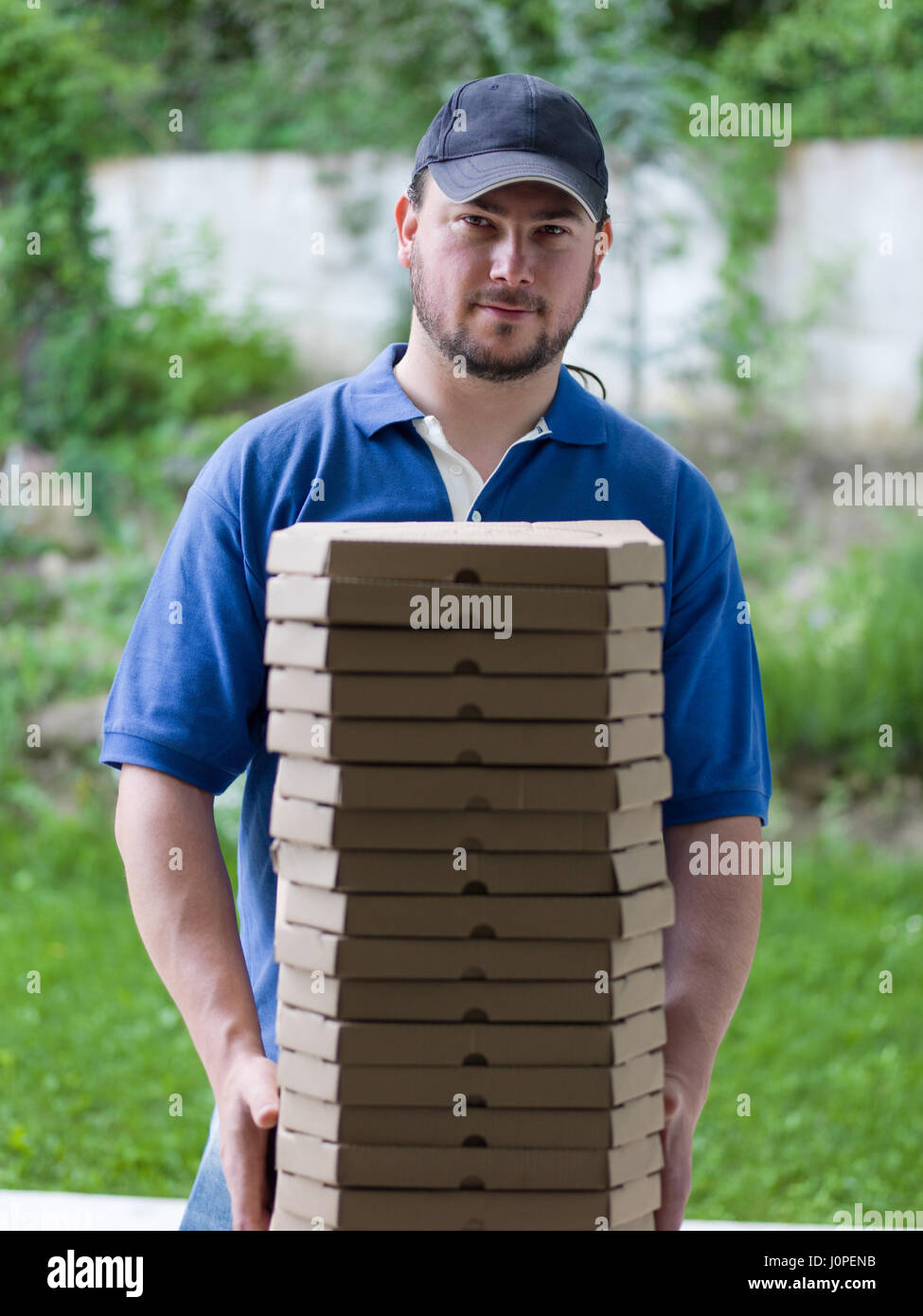 pizza delivery portrait of a young deliverers with lots of stacked ...