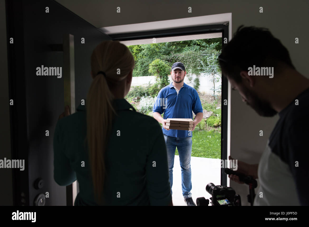Pizza Delivery Man Giving Pizza Boxes To Smiling Young Woman Stock ...