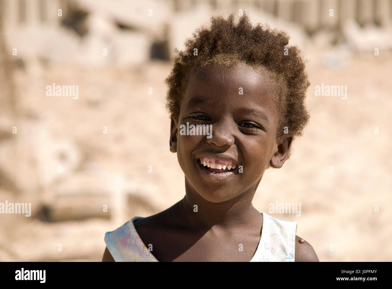 Curly african girl smiling on this portrait Stock Photo - Alamy