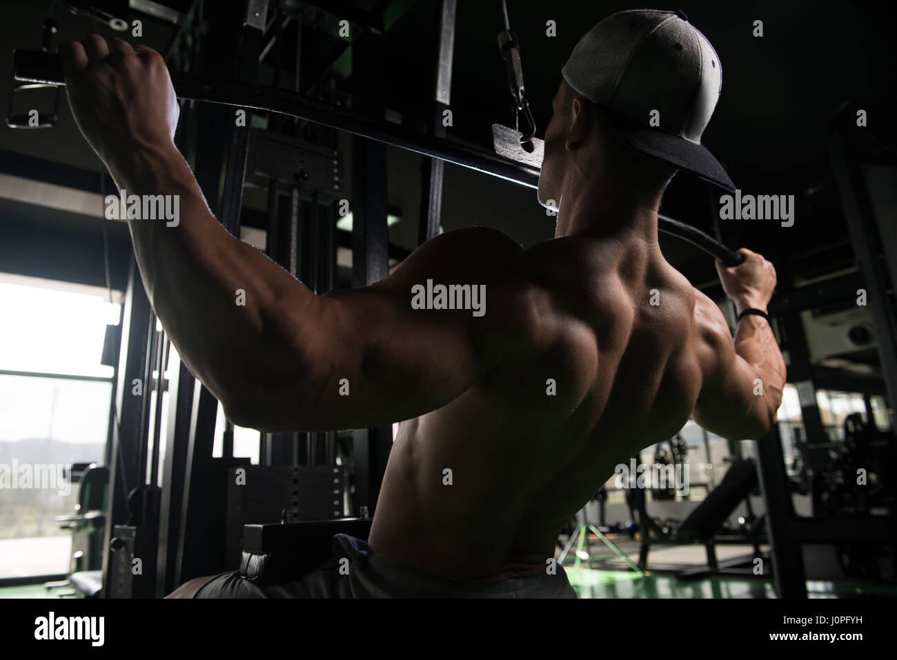 Young Bodybuilder Doing Heavy Weight Exercise For Back On Machine Stock ...