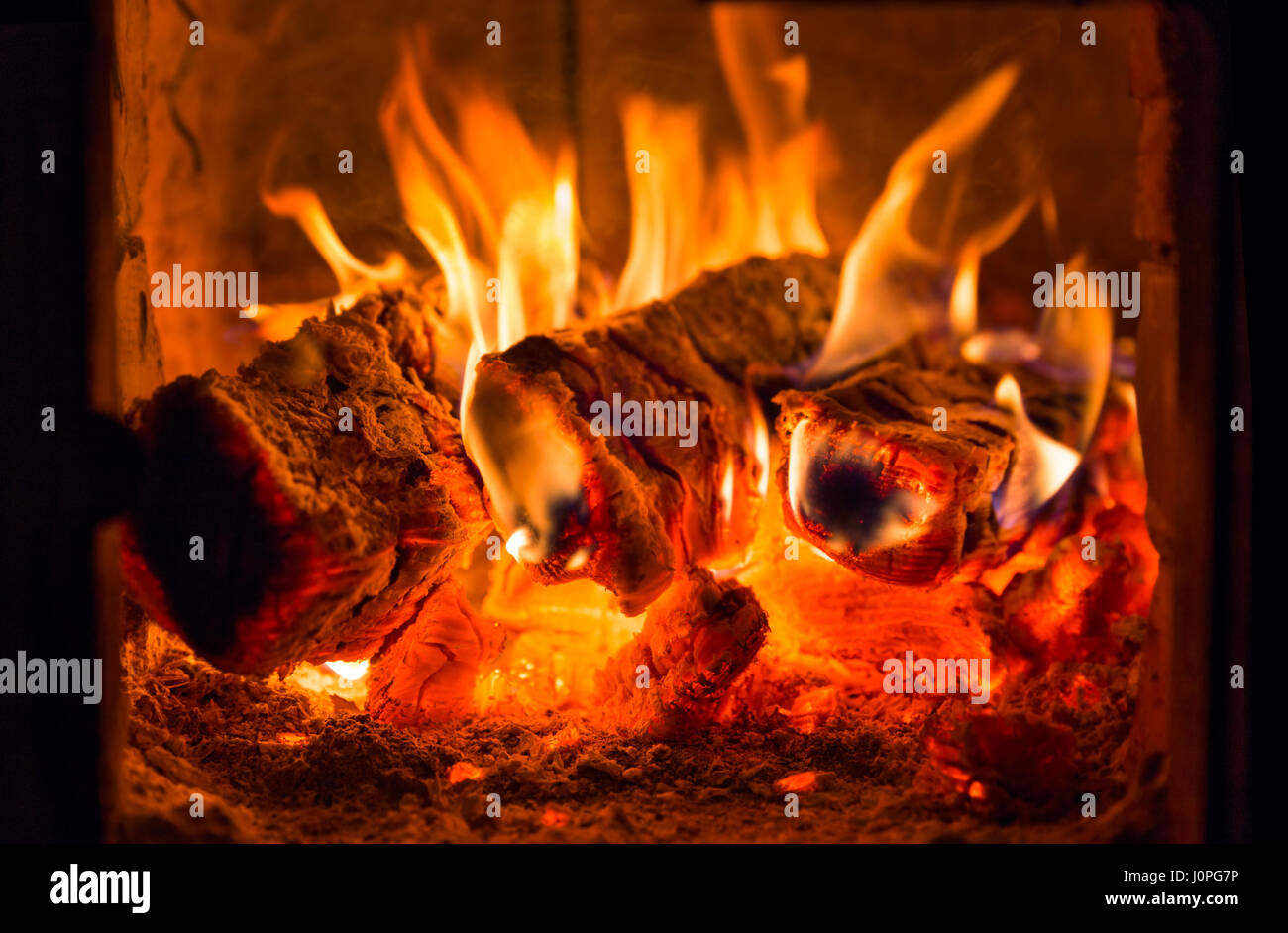 Bright fire burning with ash in fireplace Stock Photo - Alamy