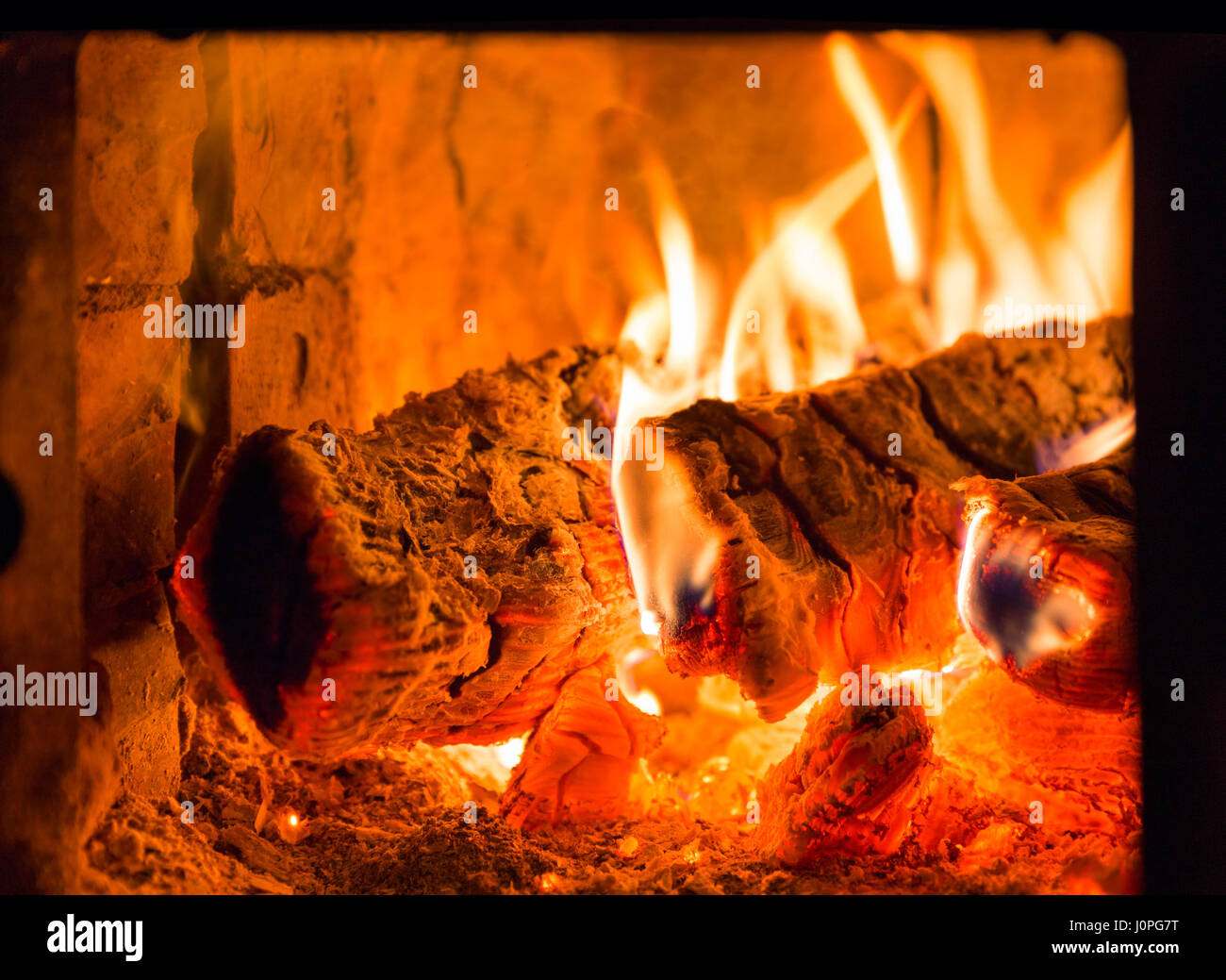 Bright fire burning with ash in fireplace Stock Photo - Alamy
