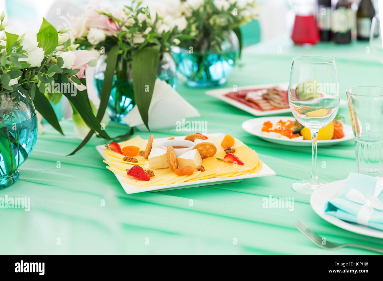 Party cheese board on a table with flowers Stock Photo - Alamy