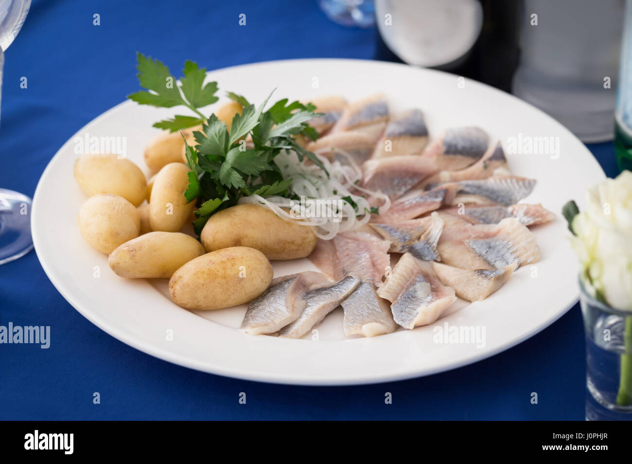 Portion of herring fish fillets with potato and onion Stock Photo - Alamy