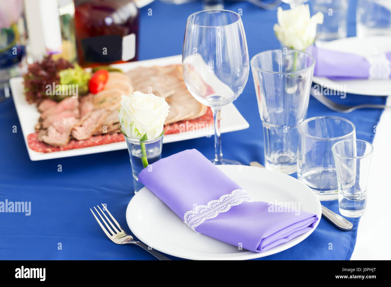 Served table layout plate and glasses Stock Photo - Alamy