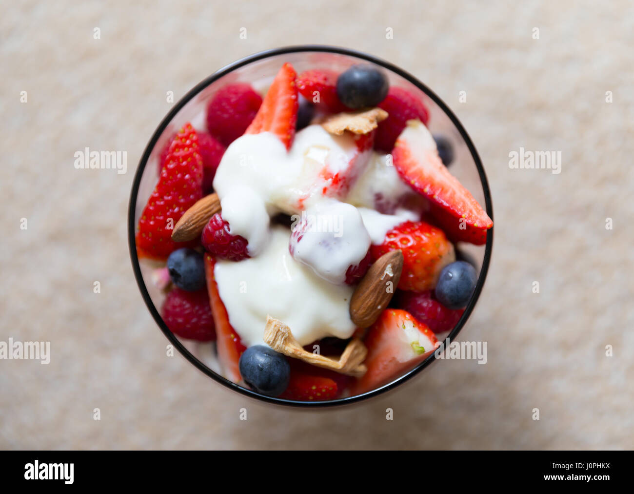Fresh yogurt with fruits and muesli on breakfast Stock Photo - Alamy
