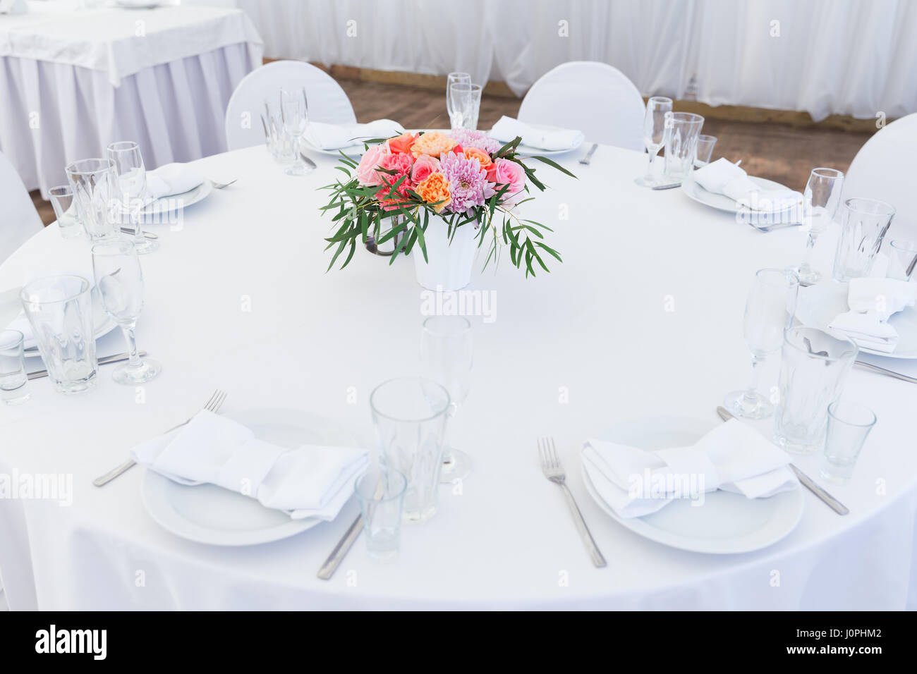 Served white wedding table layout with flowers Stock Photo - Alamy