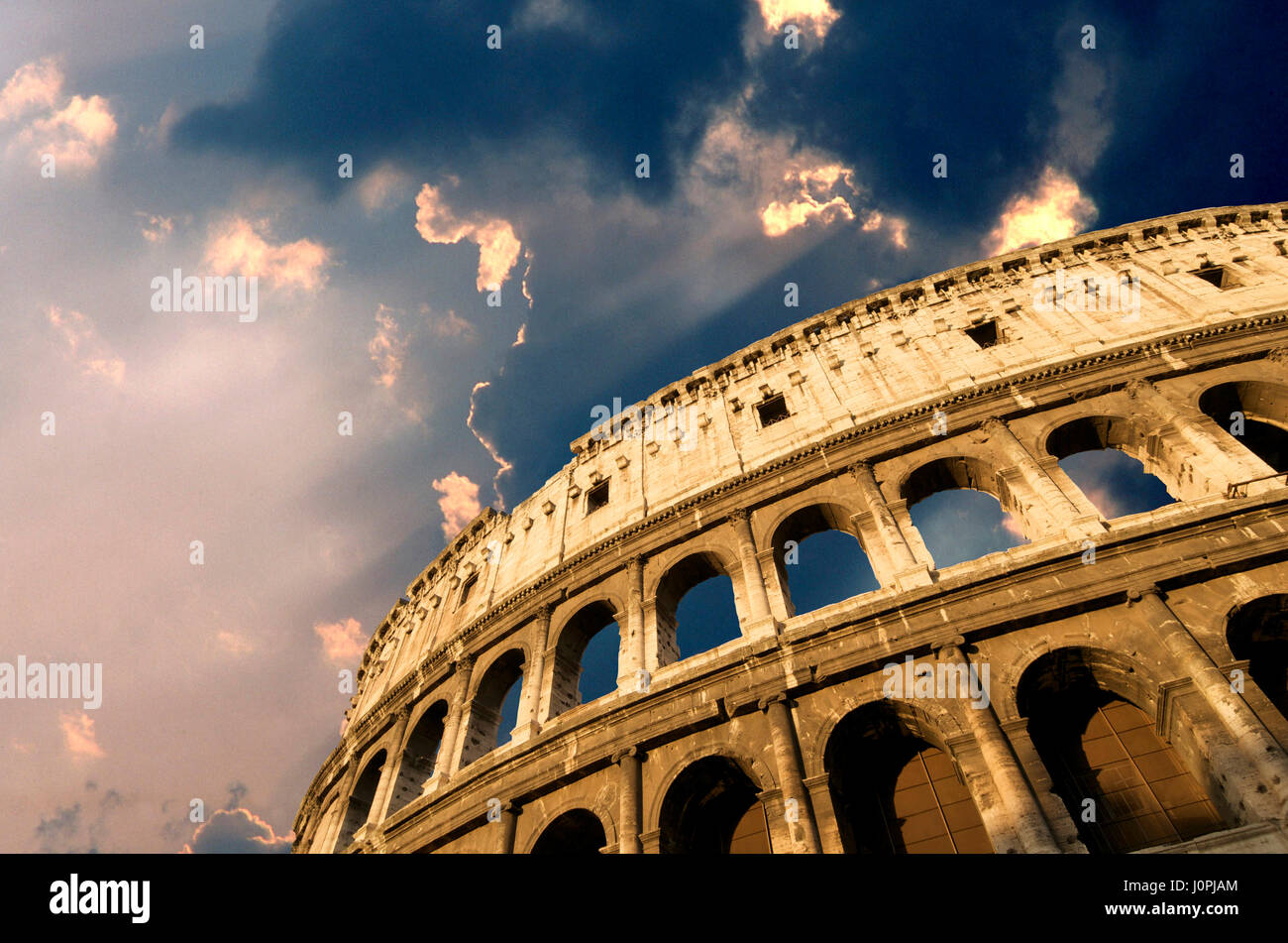 Majestic Coliseum under a dramatic sky in Rome, showcasing timeless ...