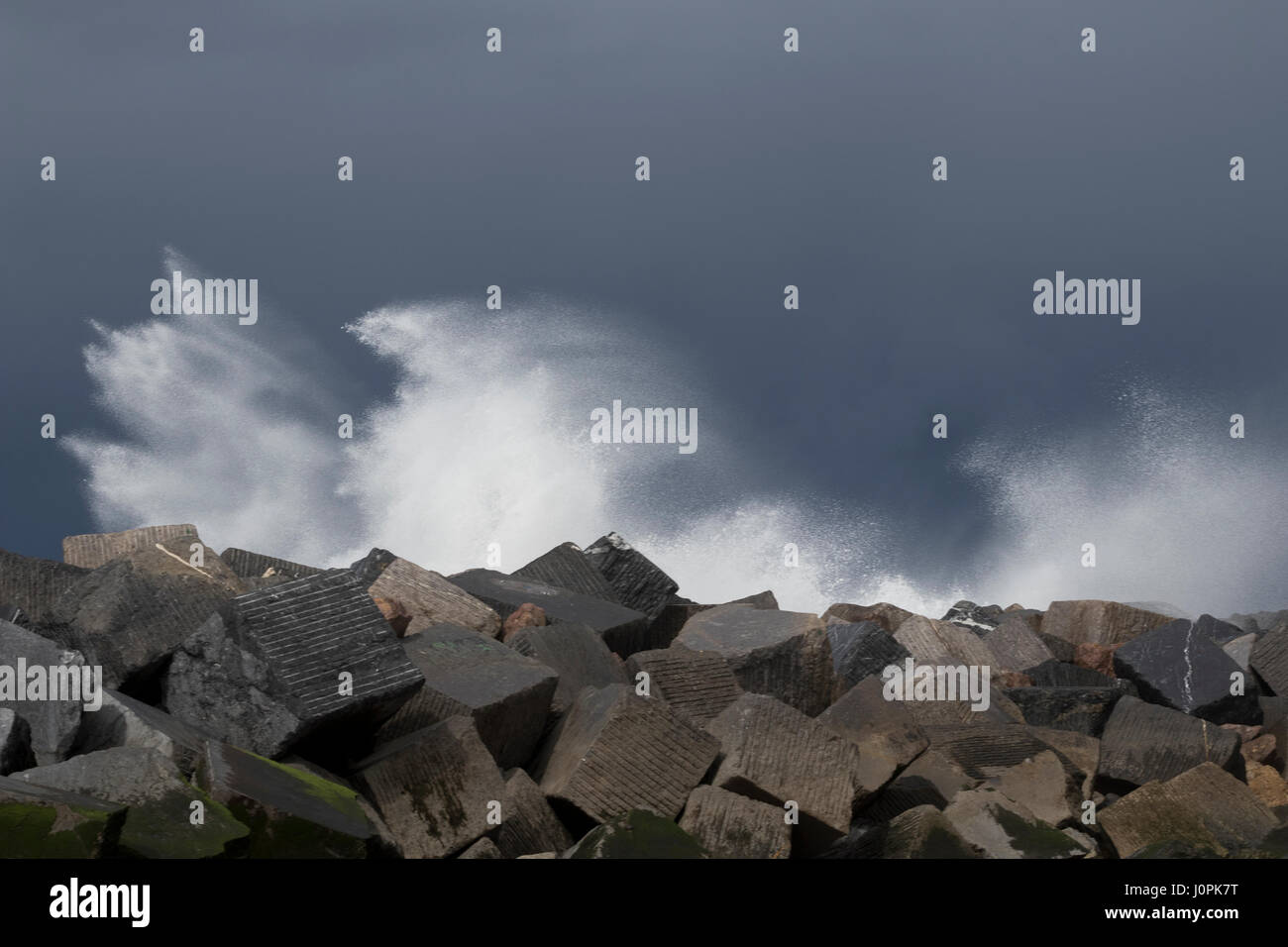 Wind makes abstract shapes with white foam from waves breaking in ...