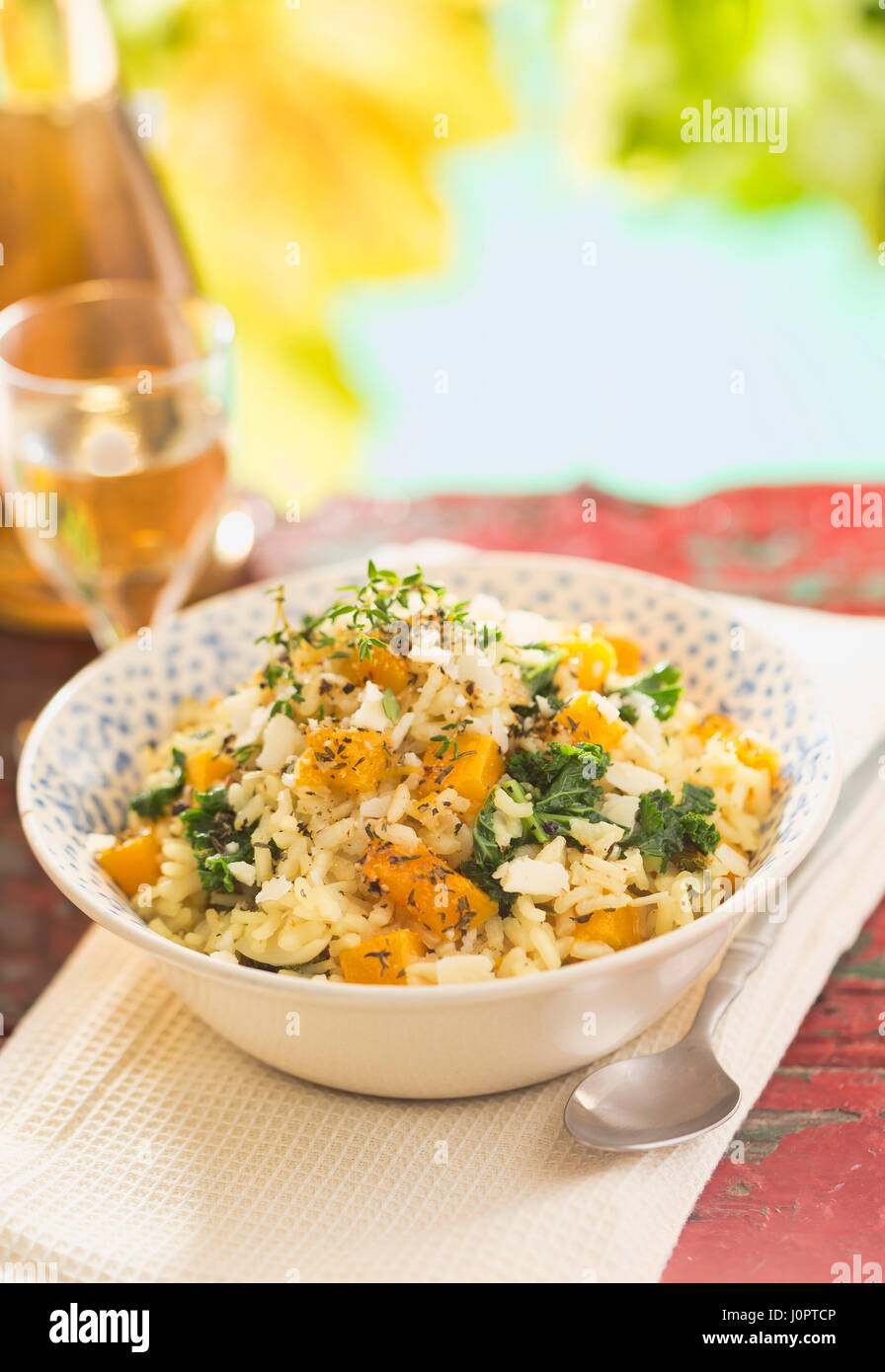 Butternut kale squash risotto with white wine on autumn outdoor table ...