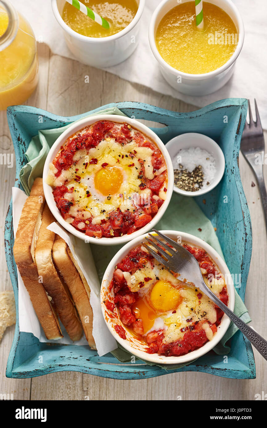 Baked egg with tomato pancetta cheese ramekins, with orange juice ...