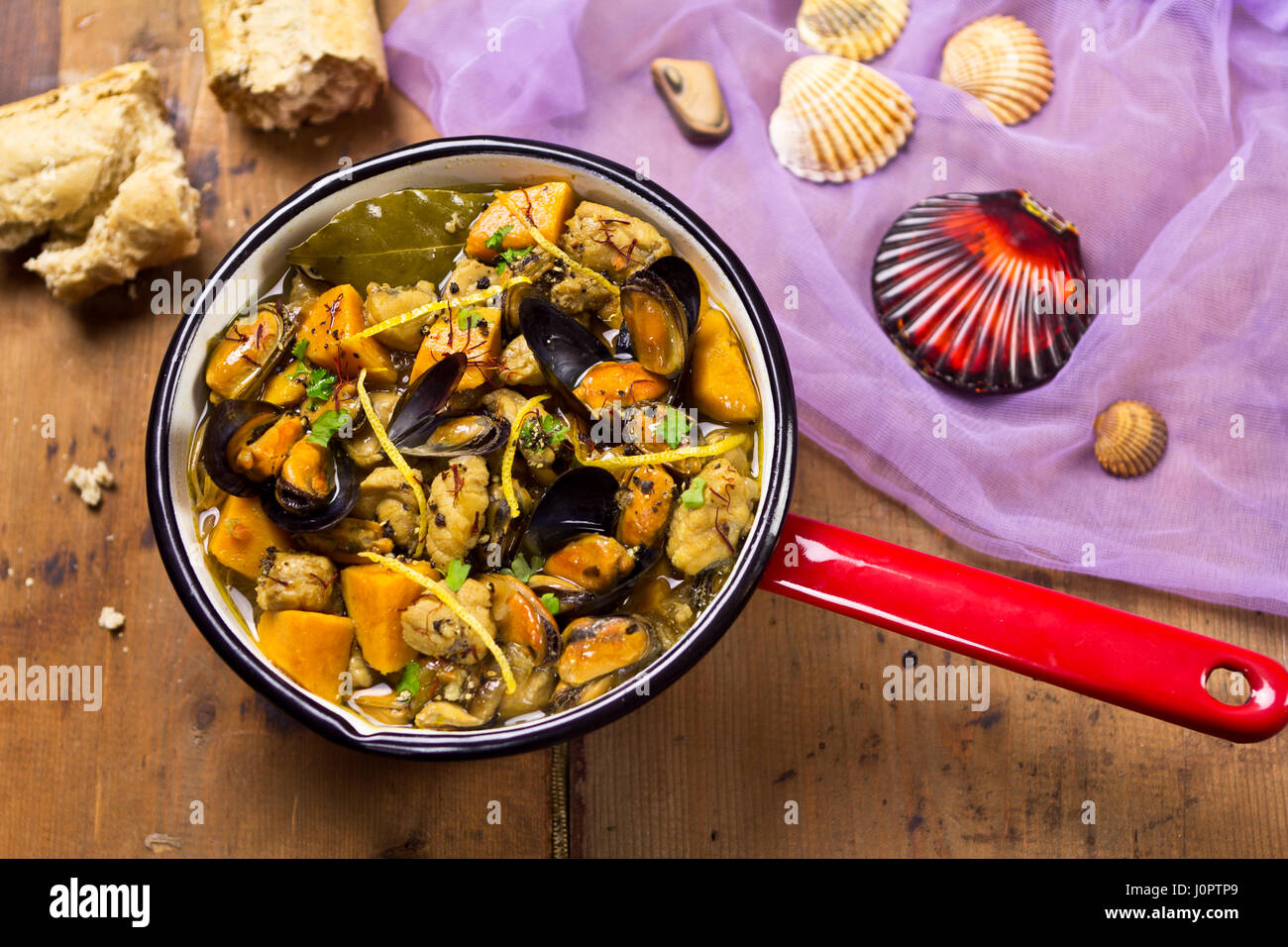 Seafood monk fish sweet potato soup in red pot Stock Photo - Alamy