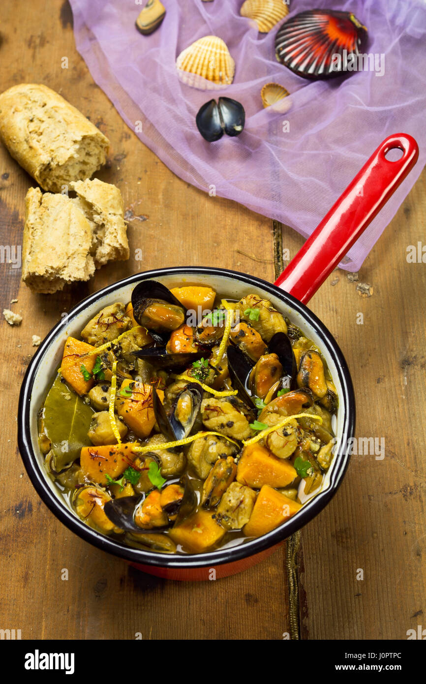 Seafood monk fish sweet potato soup in red pot Stock Photo - Alamy
