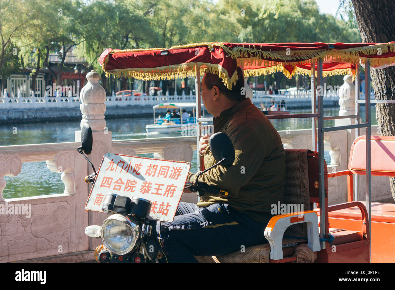 25,Oct,2014 -Beijing,China. side profile of Man on rickshaws at Houhai ...