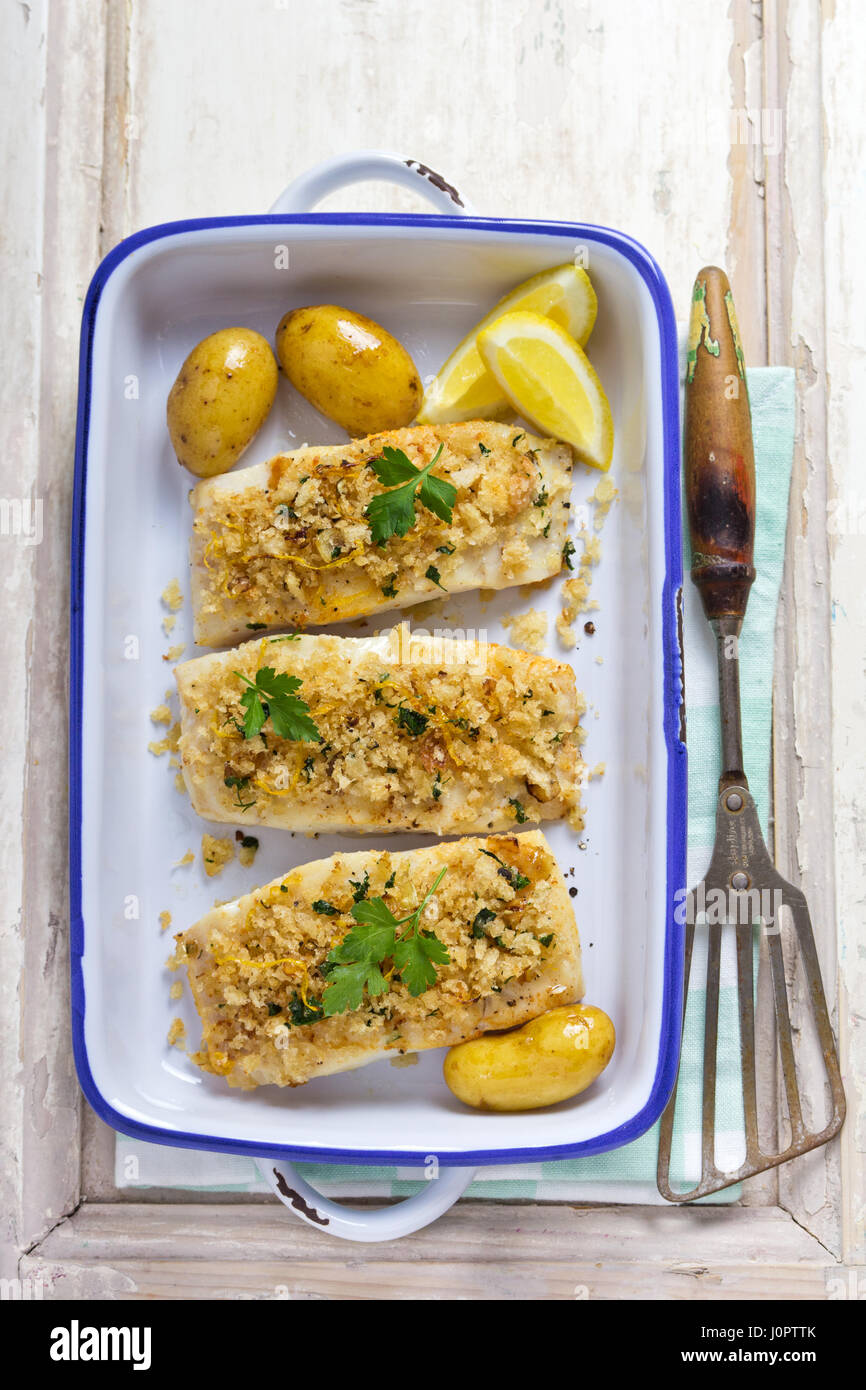 Baked cod fillets with breadcrumbs and baby potatoes Stock Photo - Alamy
