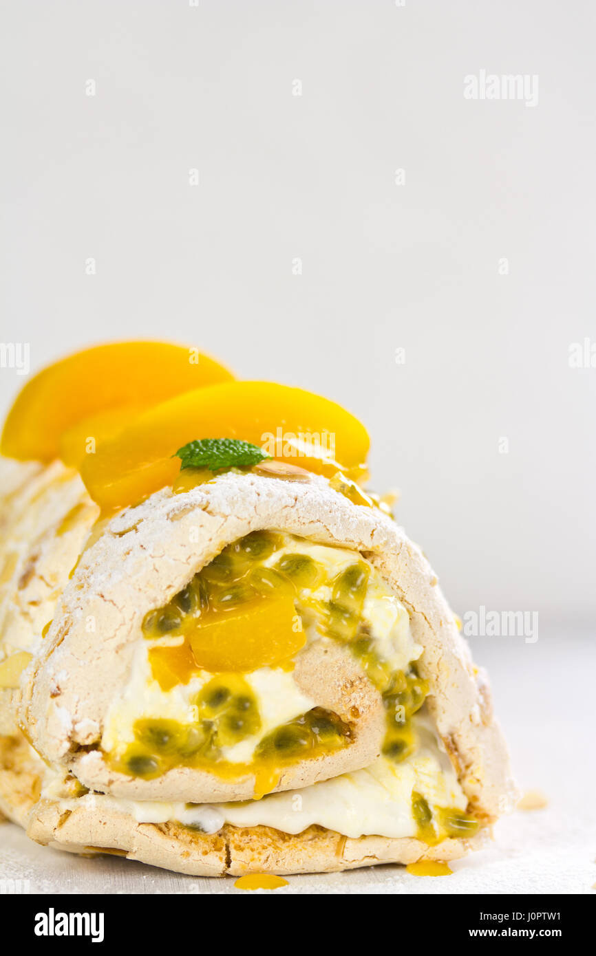 Meringue roulade with cream and passion fruit Stock Photo - Alamy