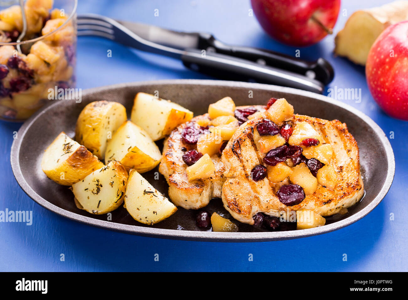 Pork chops with baby potatoes, apple chutney Stock Photo - Alamy