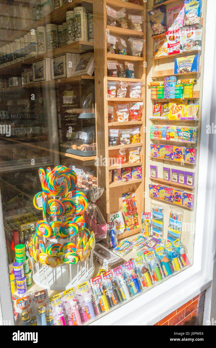 Traditional sweets and brightly coloured lollipops in the window of a ...