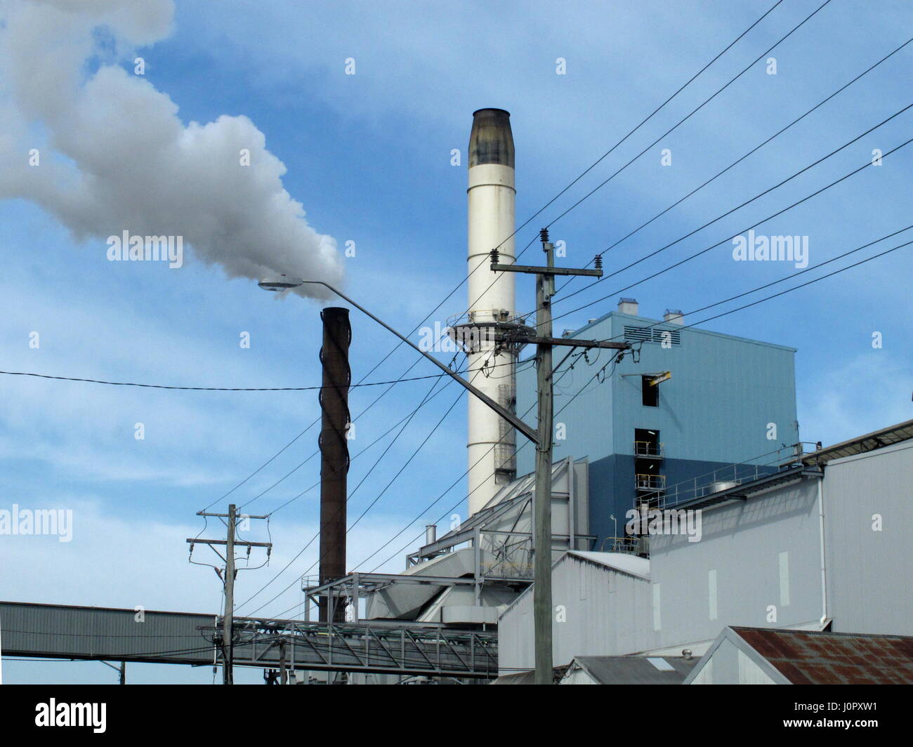 Smoke Stack of sugar mill with blue sky background Stock Photo - Alamy