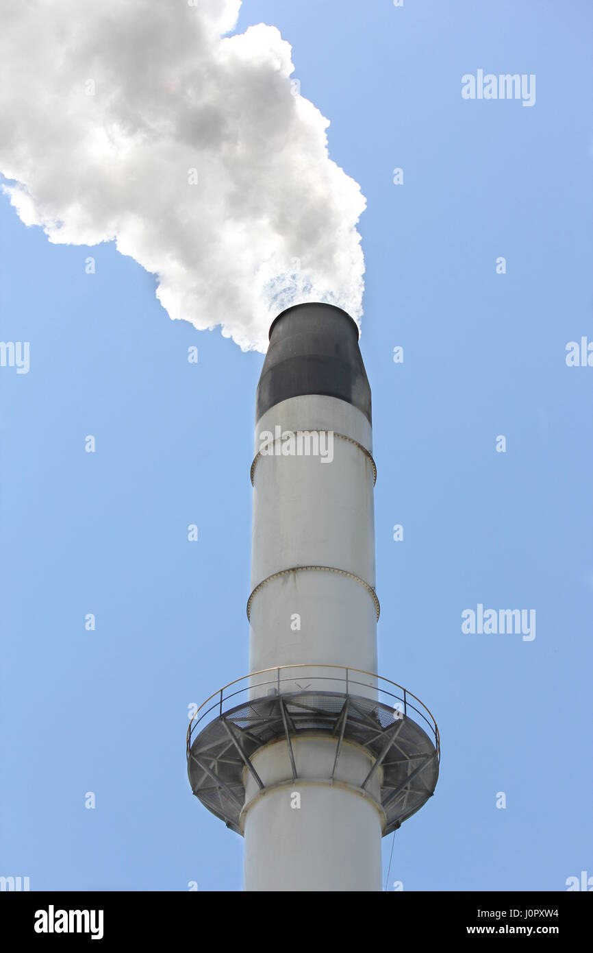 Smoke Stack of sugar mill with blue sky background Stock Photo - Alamy