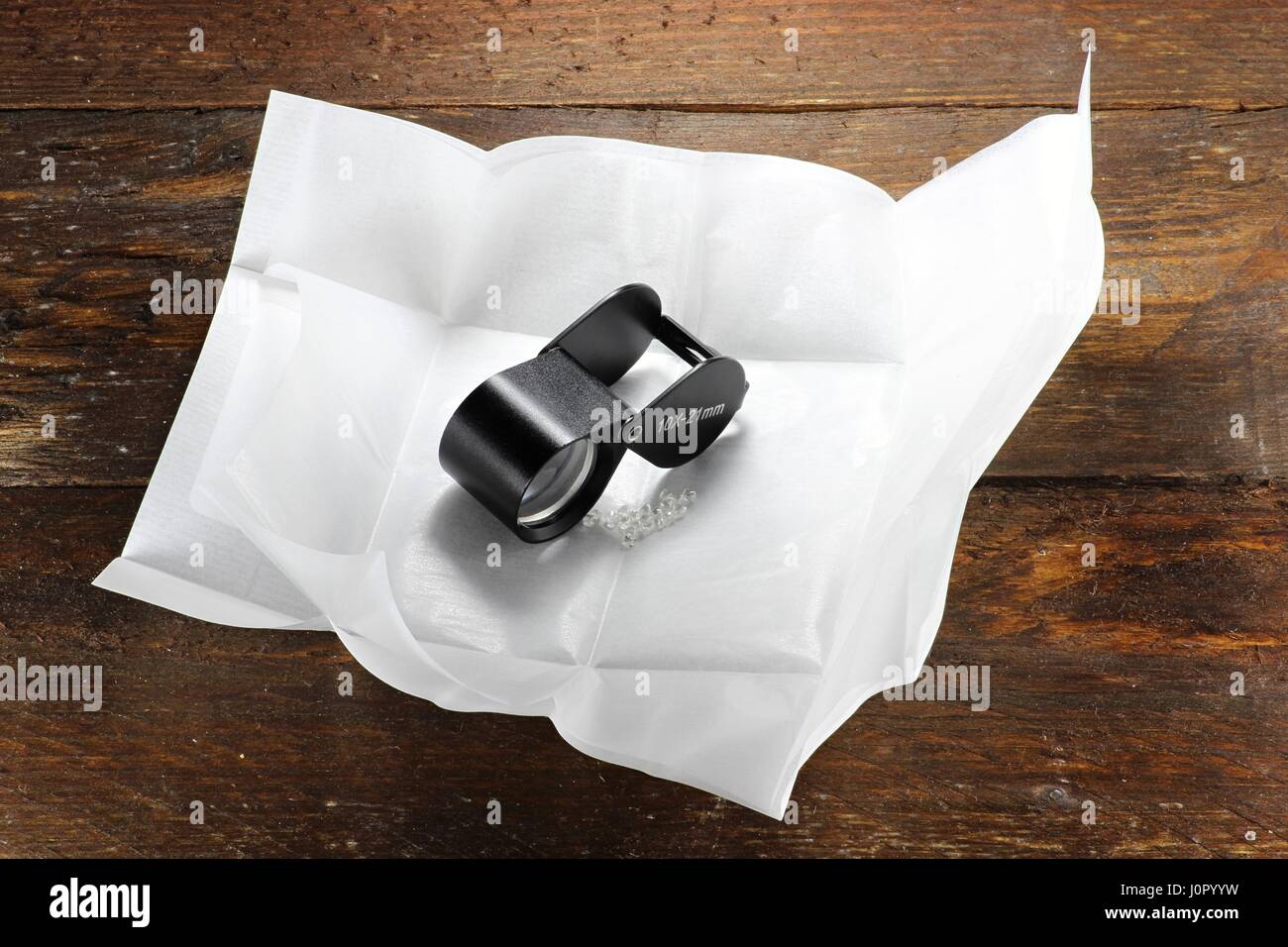 rough diamonds in a traditional diamond parcel on wooden background ...