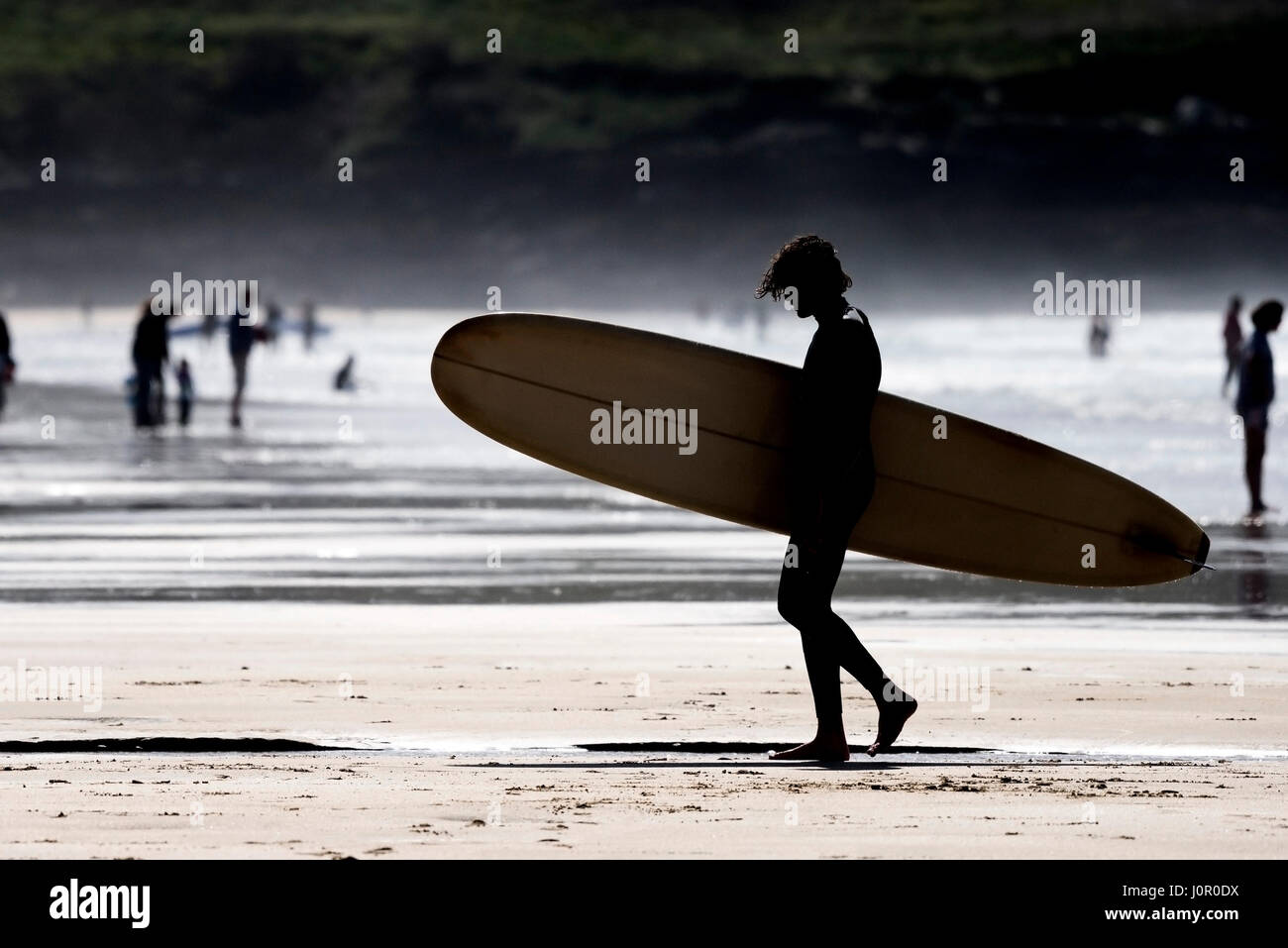 UK surfing Fistral beach Newquay Silhouette Surfer Tired Leaving the ...