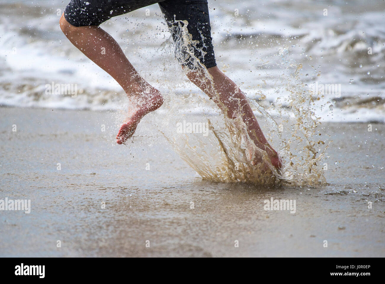Fistral Newquay Person running along shoreline Splash Splashing Runner ...